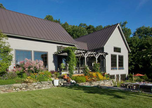 An antique barn, rebuilt time by timber, set in the sunlight ...